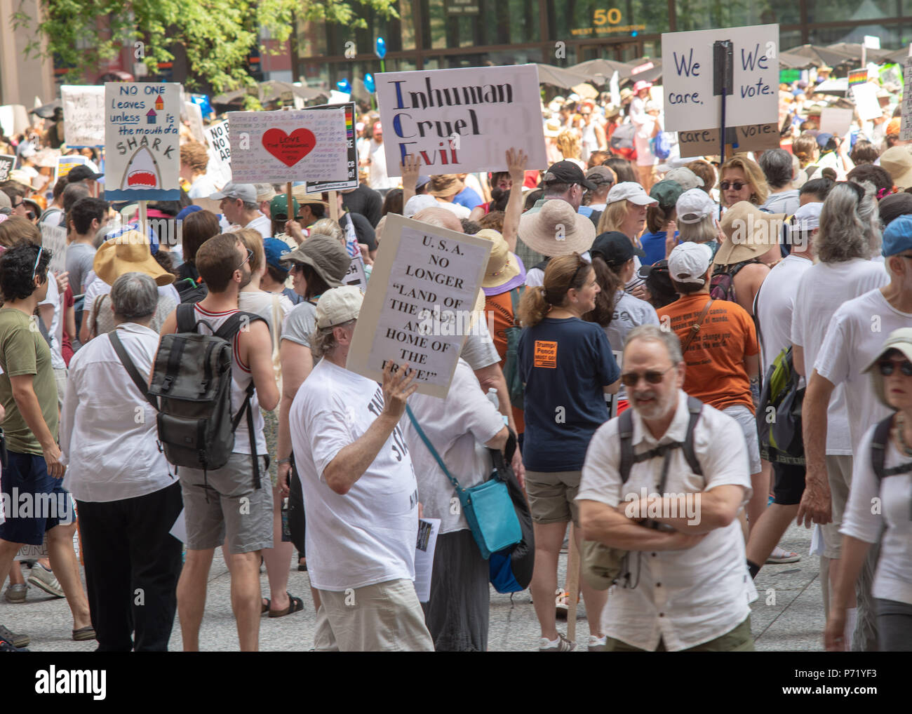 People walking together with protest signs hi-res stock photography and ...