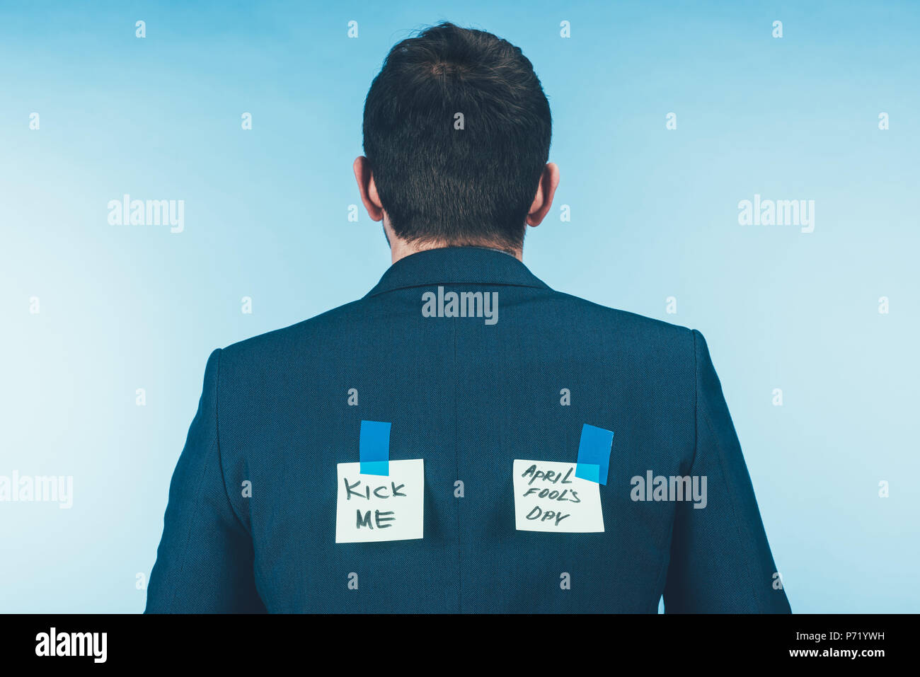 back view of businessman in suit notes with lettering on back, april ...