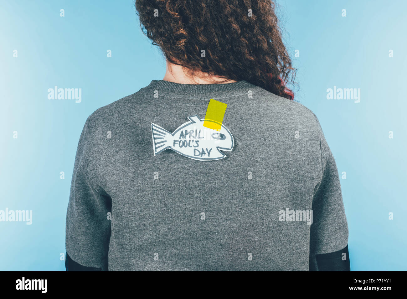 back view of woman with hand drawn fish on back, april fools day ...