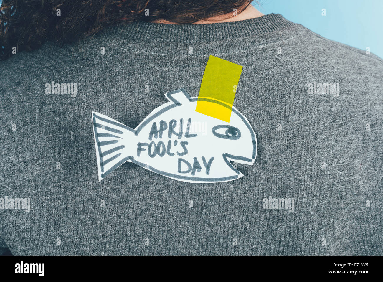 back view of woman with hand drawn fish on back, april fools day ...