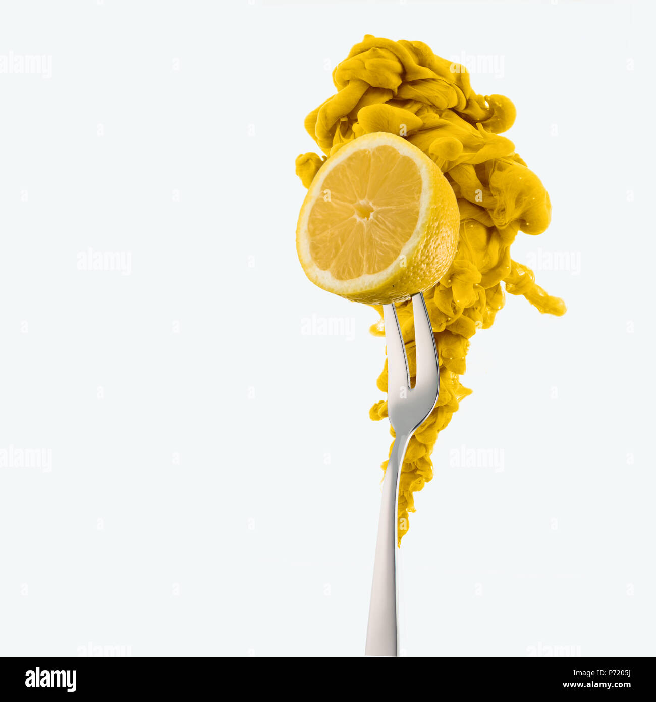 half of lemon on fork and yellow ink isolated on white Stock Photo - Alamy