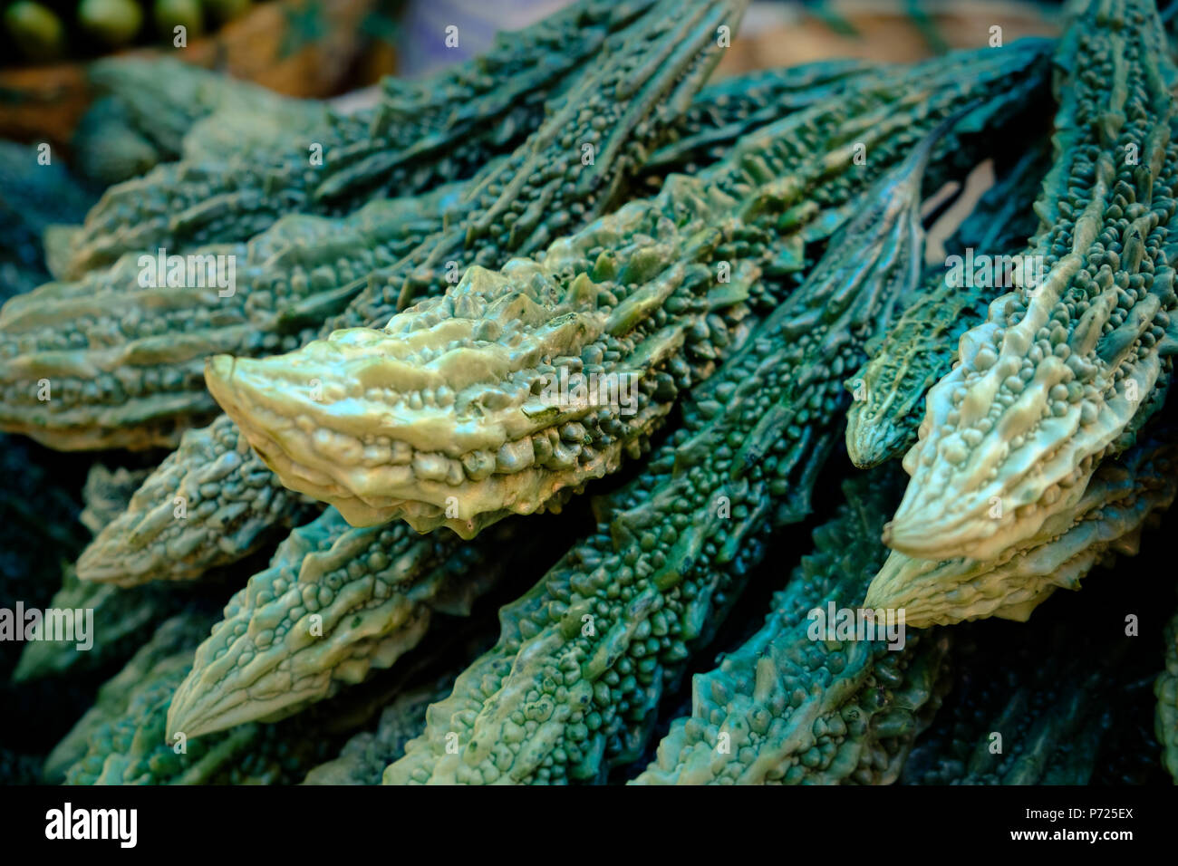 Fresh indian kakdi cuccumbers lying on market stall, close-up side view ...
