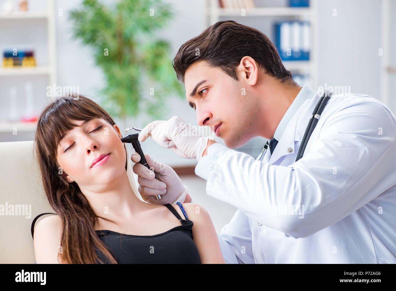 Doctor checking patients ear during medical examination Stock Photo - Alamy