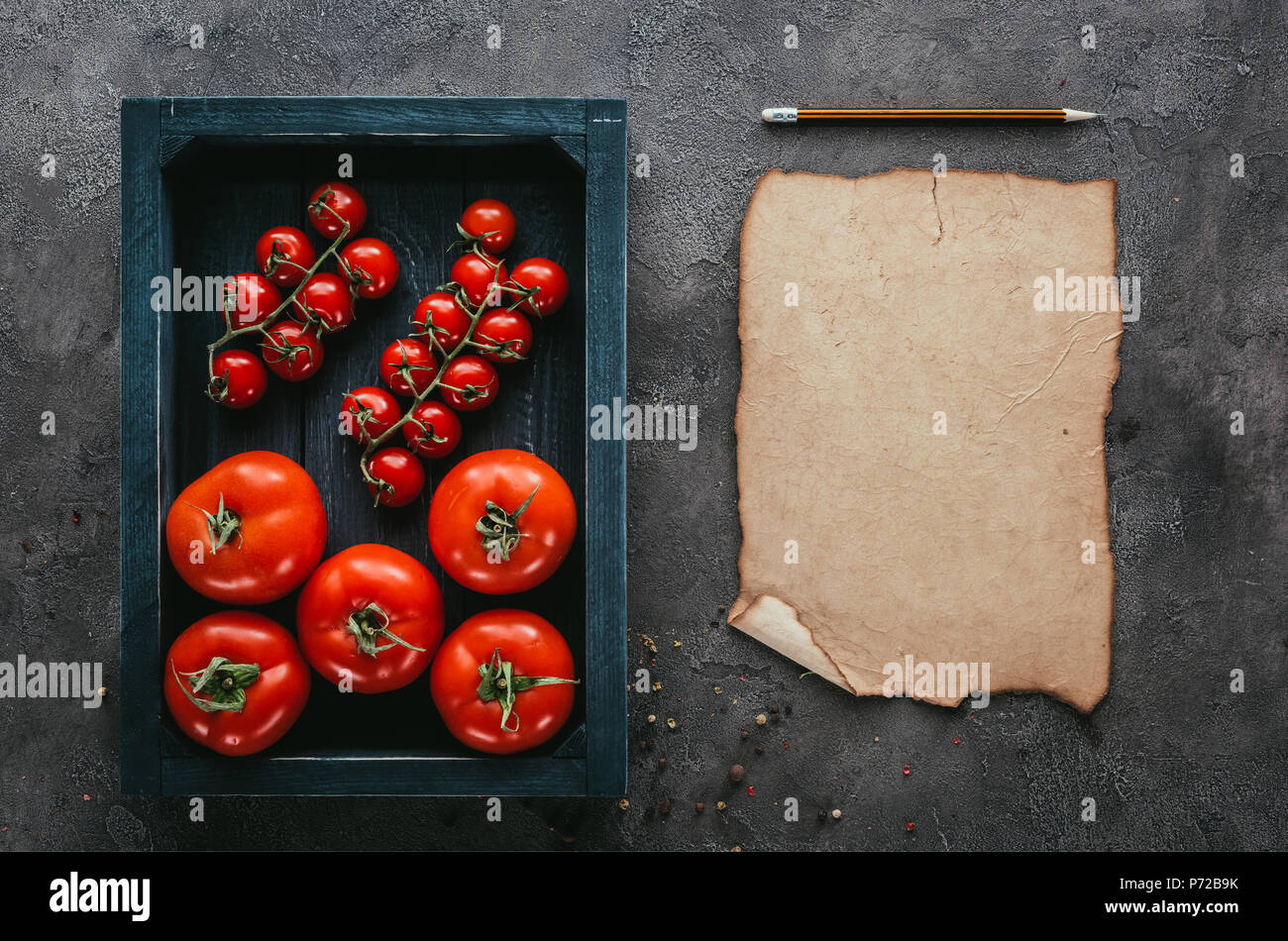 top view of tomatoes in box and blank paper on concrete surface Stock ...