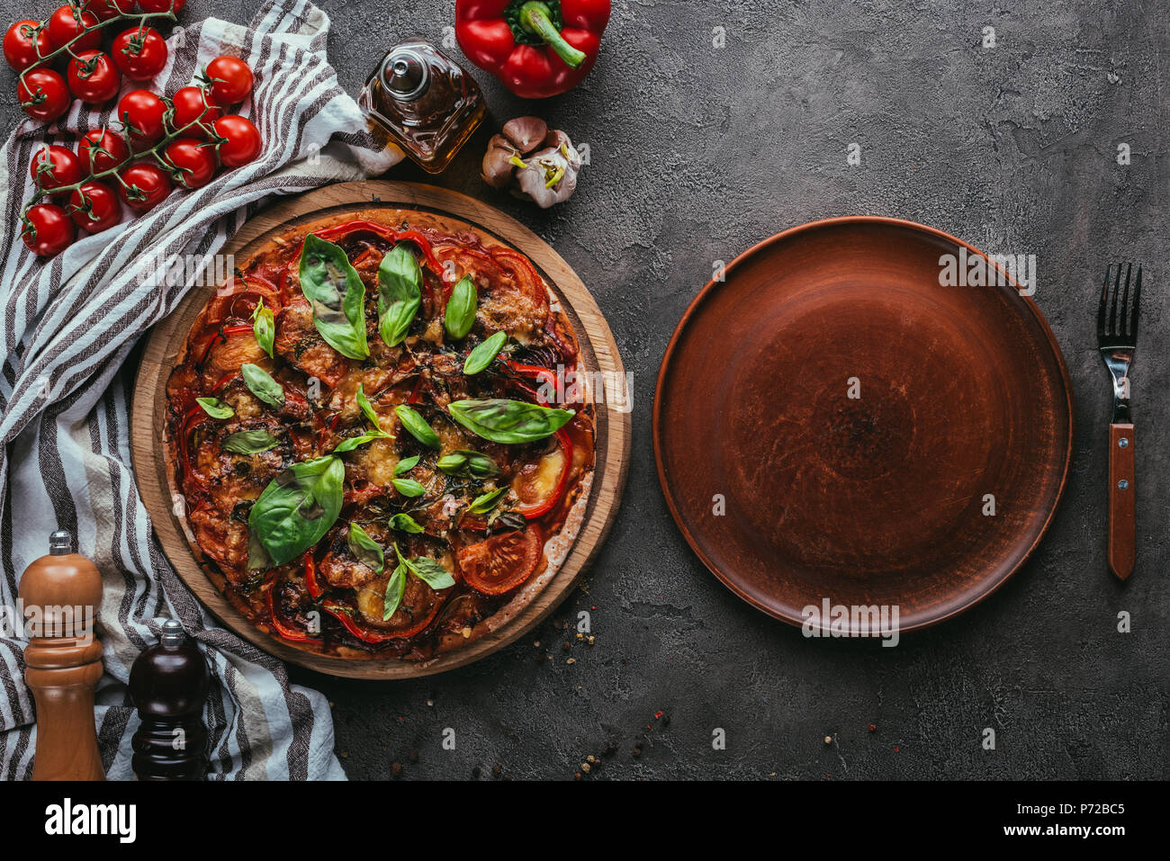 top view of delicious pizza with rustic plate on concrete table Stock ...
