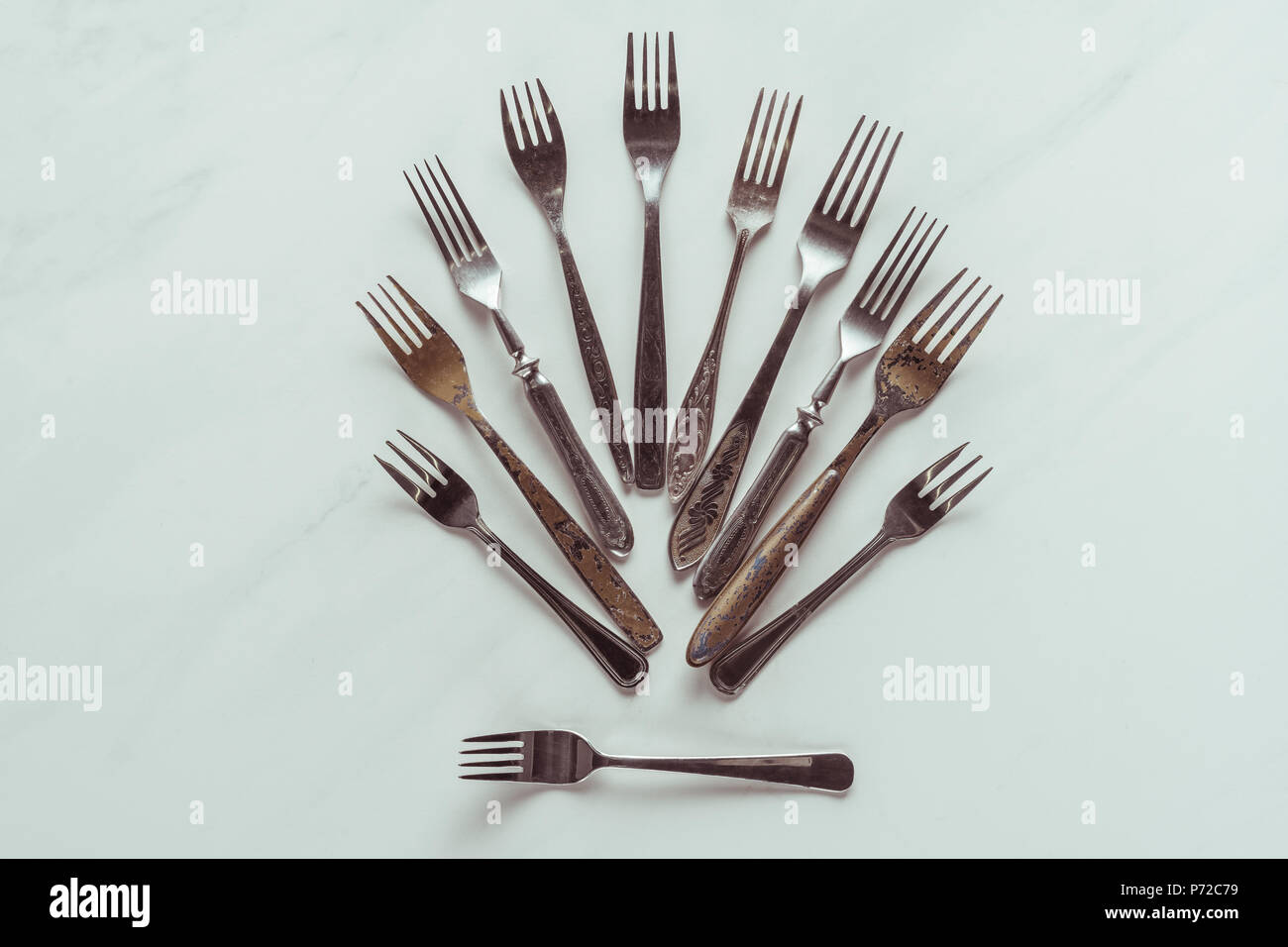Composition of old metal forks on white background Stock Photo - Alamy