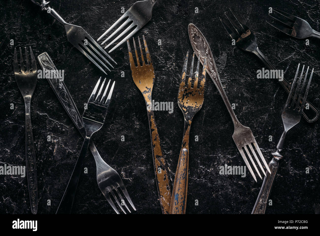 Old metal forks on rusted background Stock Photo - Alamy