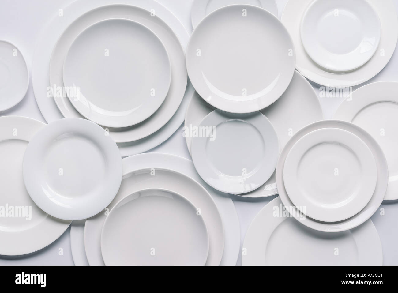 white plates composition on white background Stock Photo - Alamy