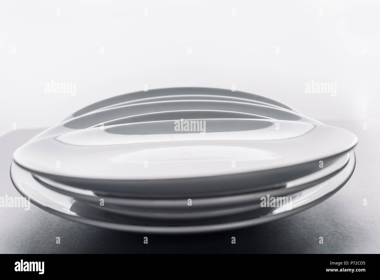 Shiny white kitchen ceramic plates Stock Photo - Alamy