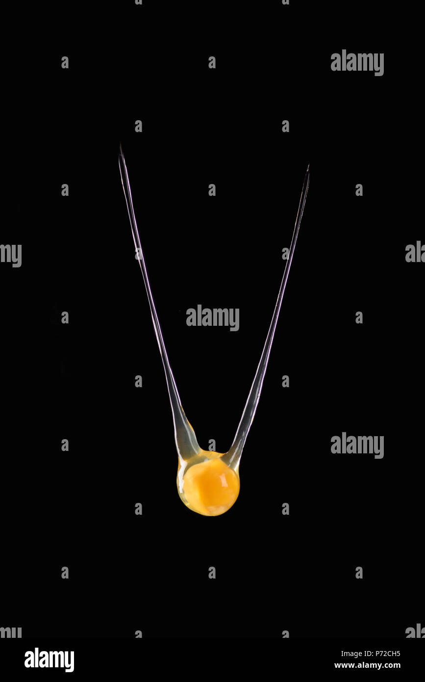 falling uncooked chicken egg isolated on black Stock Photo - Alamy