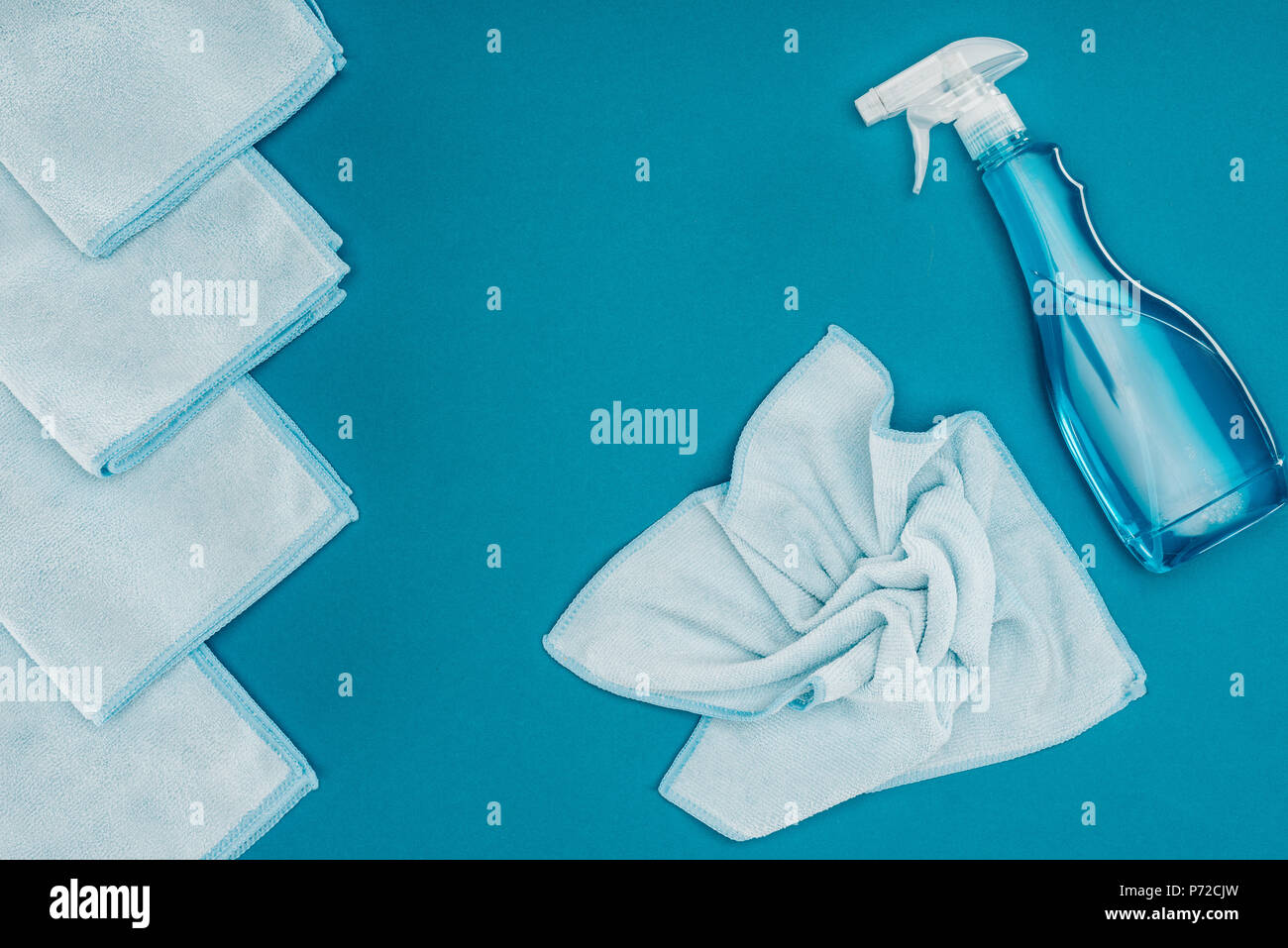 elevated view of blue rags and spray bottle isolated on blue Stock ...