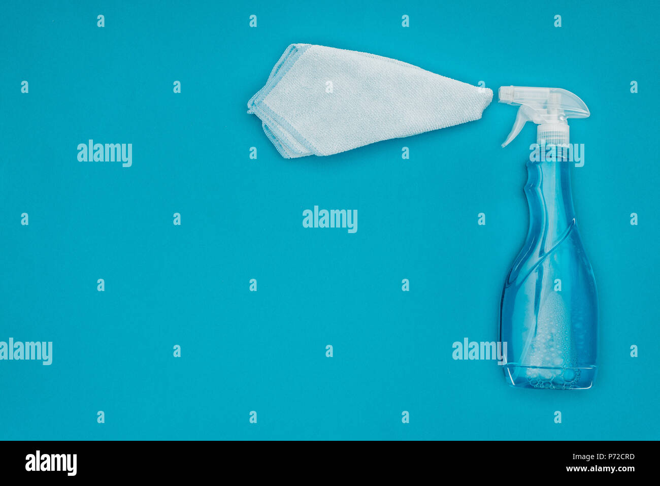 top view of spray bottle and rag isolated on blue Stock Photo - Alamy