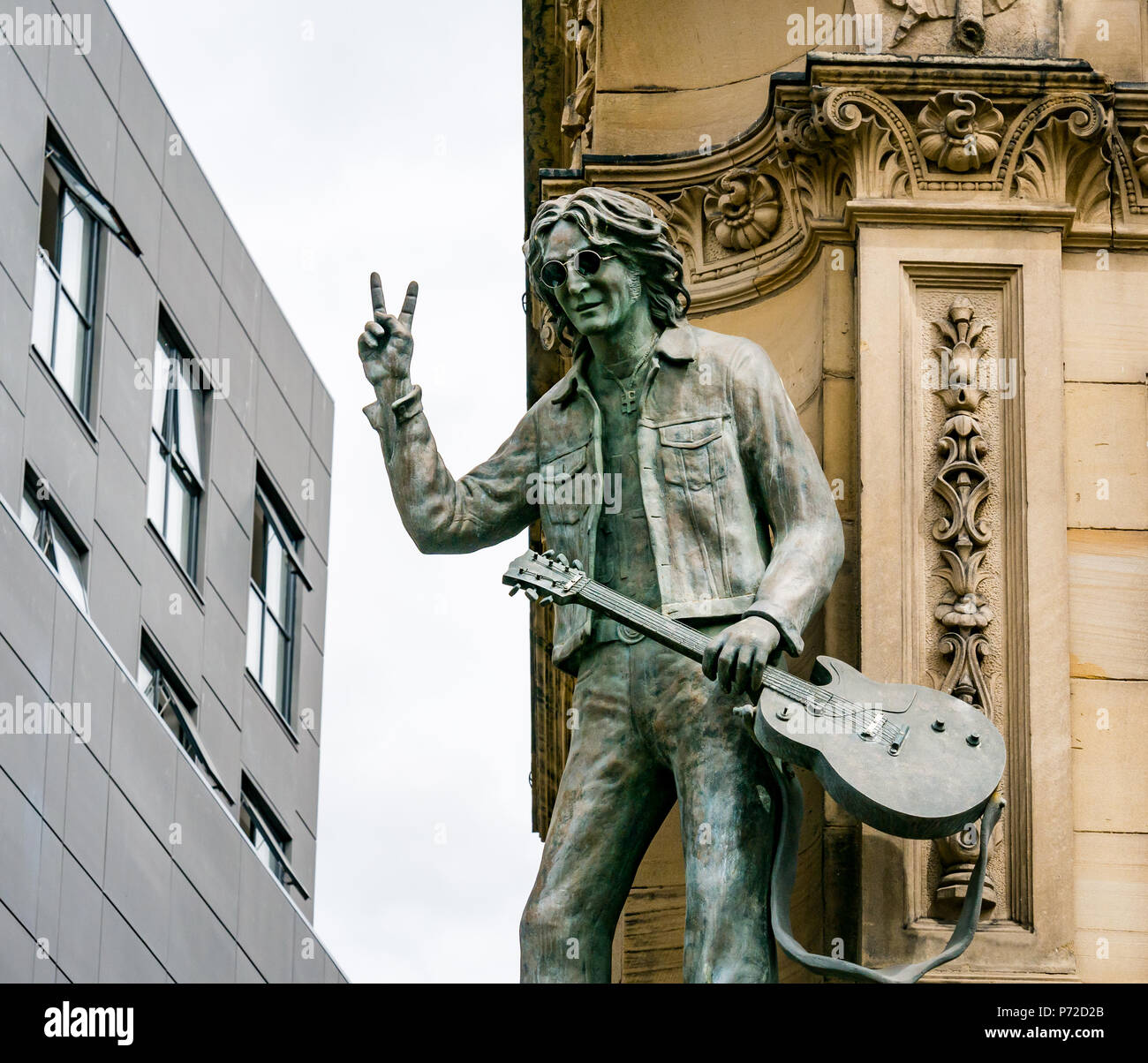 Statue of John Lennon holding guitar and giving V sign, Hard Day's ...