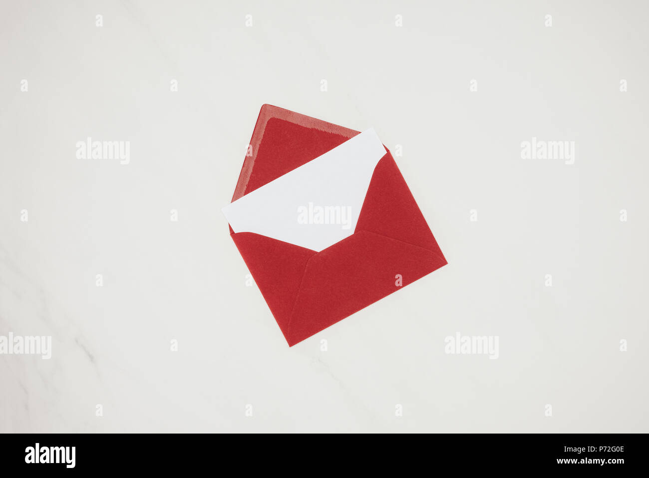 top view of opened red envelope with blank paper isolated on white ...