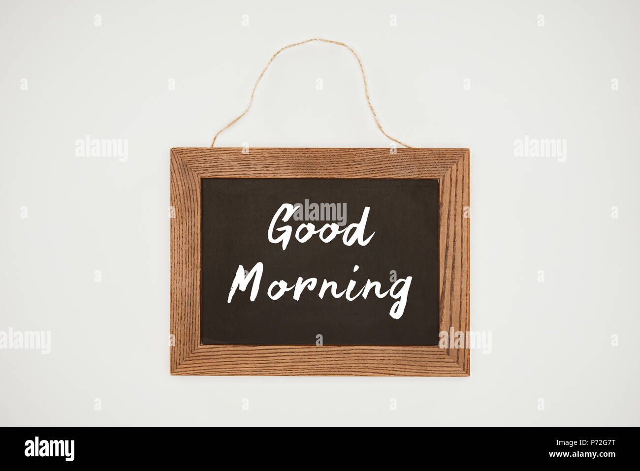 good morning lettering on chalkboard with wooden frame and thread ...