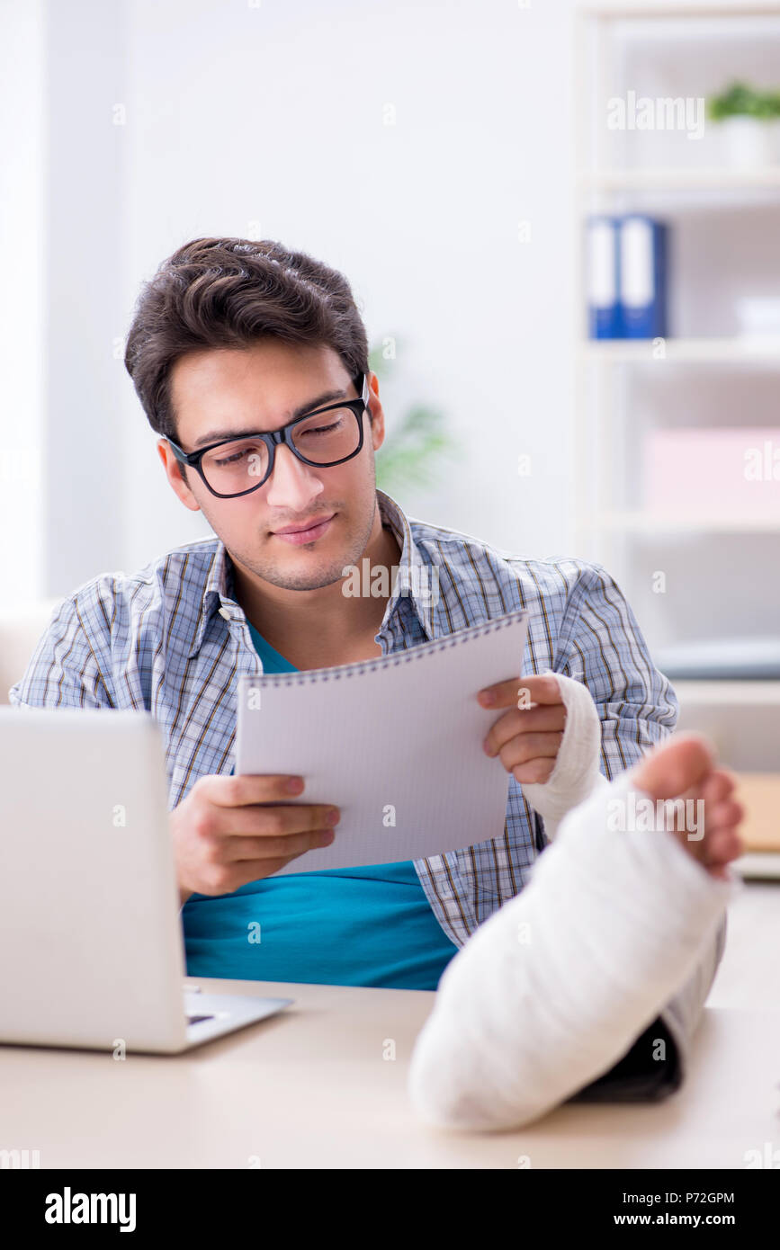 Freelancer with foot injury working from home Stock Photo - Alamy