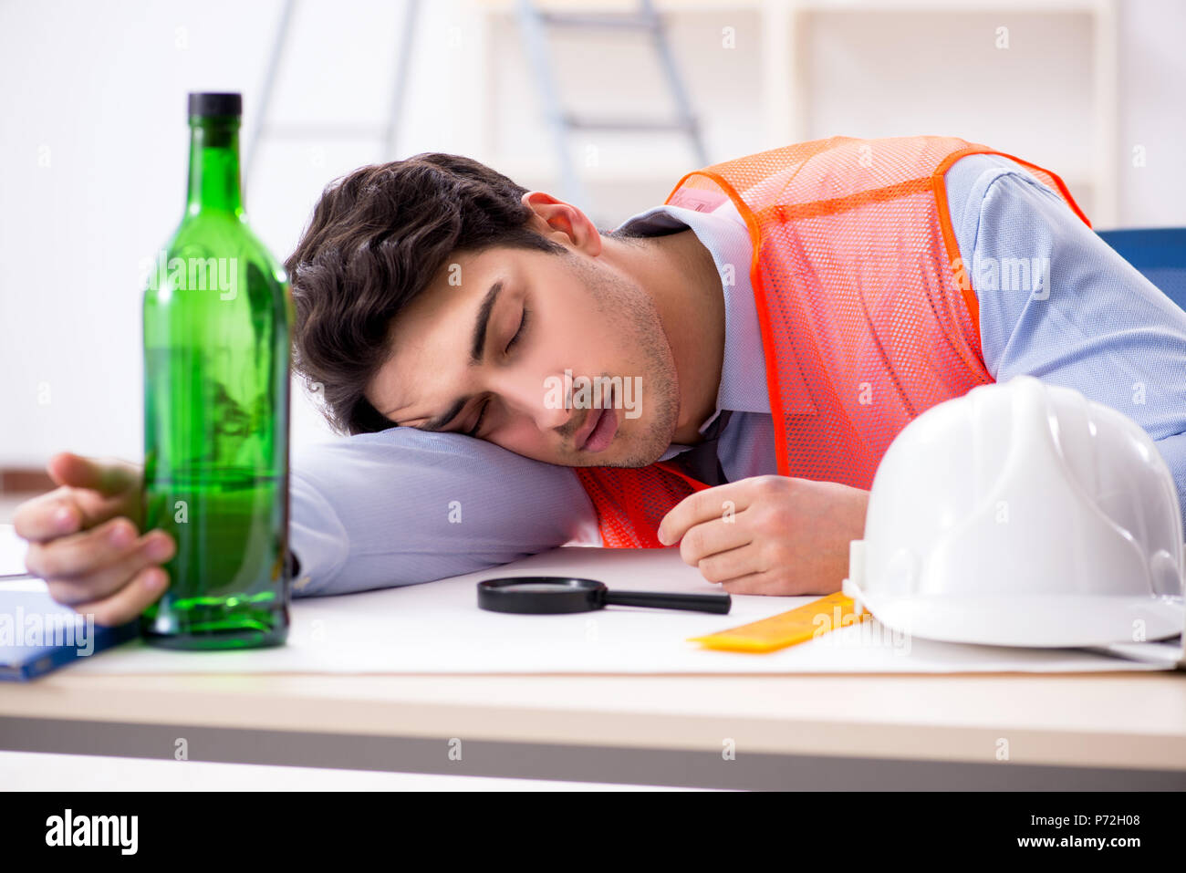 Drunk engineer working in the workshop Stock Photo - Alamy