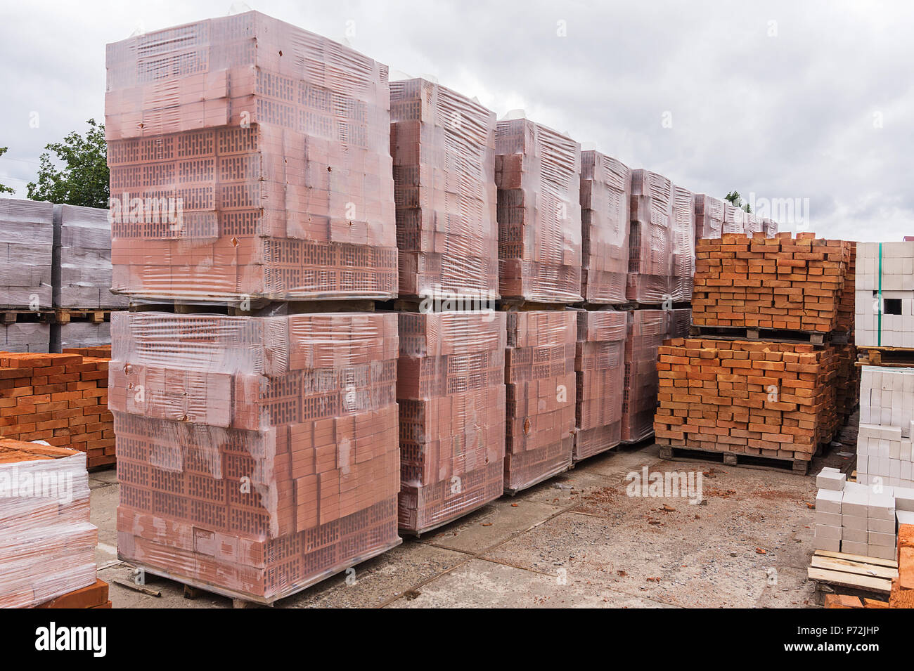 Folded and packed red bricks Stock Photo - Alamy