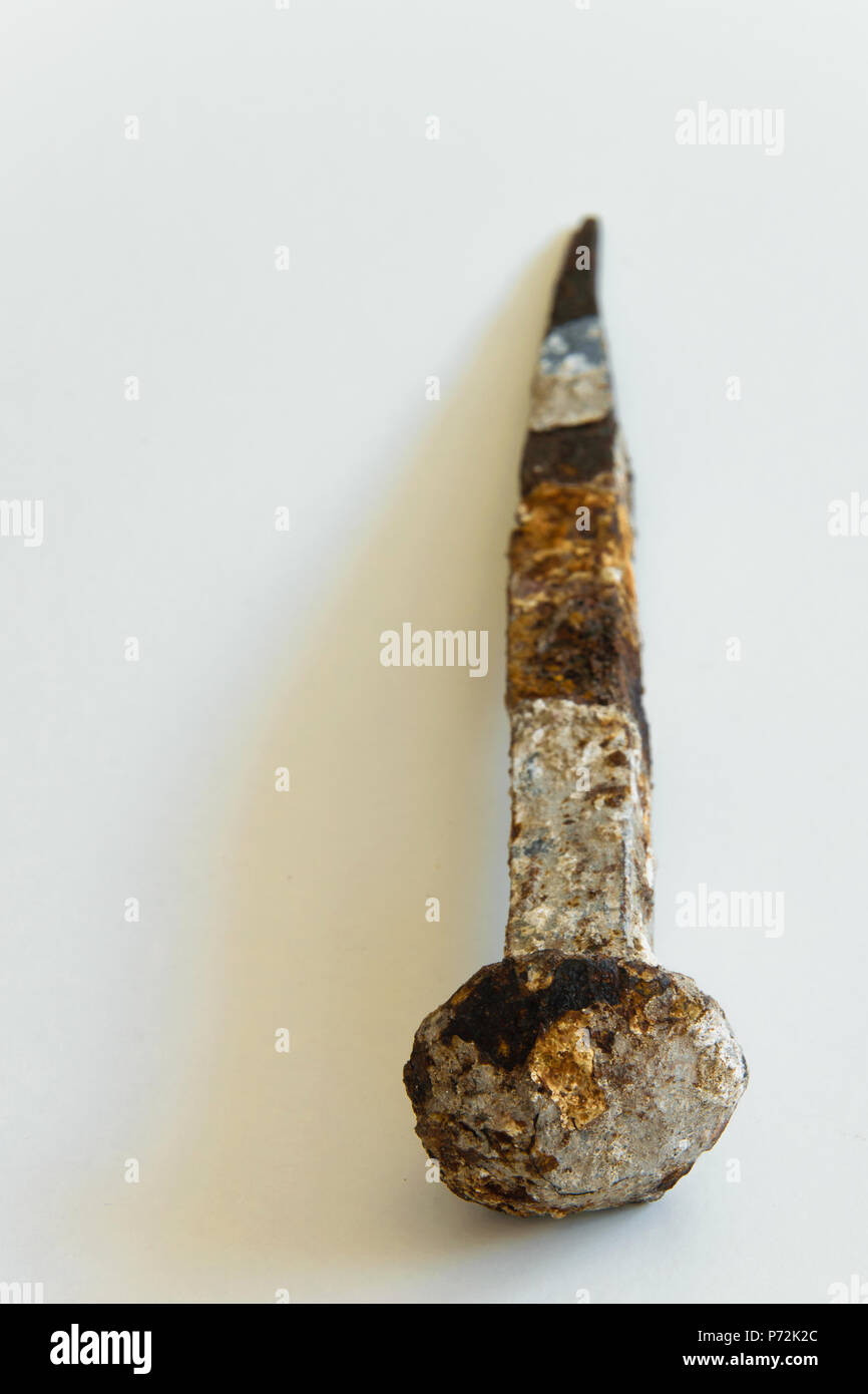 An ancient iron nail on white background Stock Photo - Alamy
