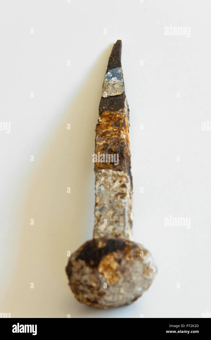 An ancient iron nail on white background Stock Photo - Alamy