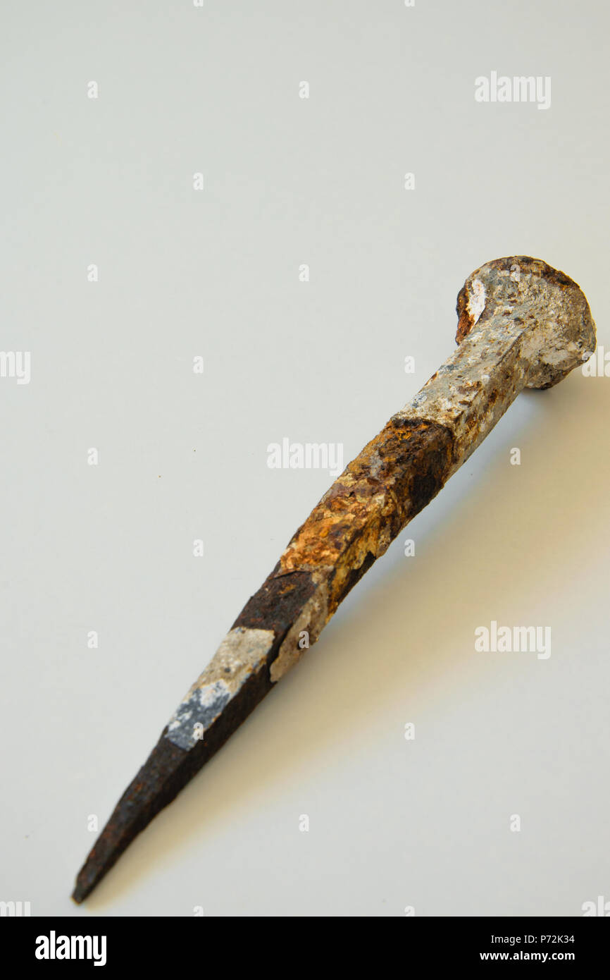An ancient iron nail on white background Stock Photo - Alamy
