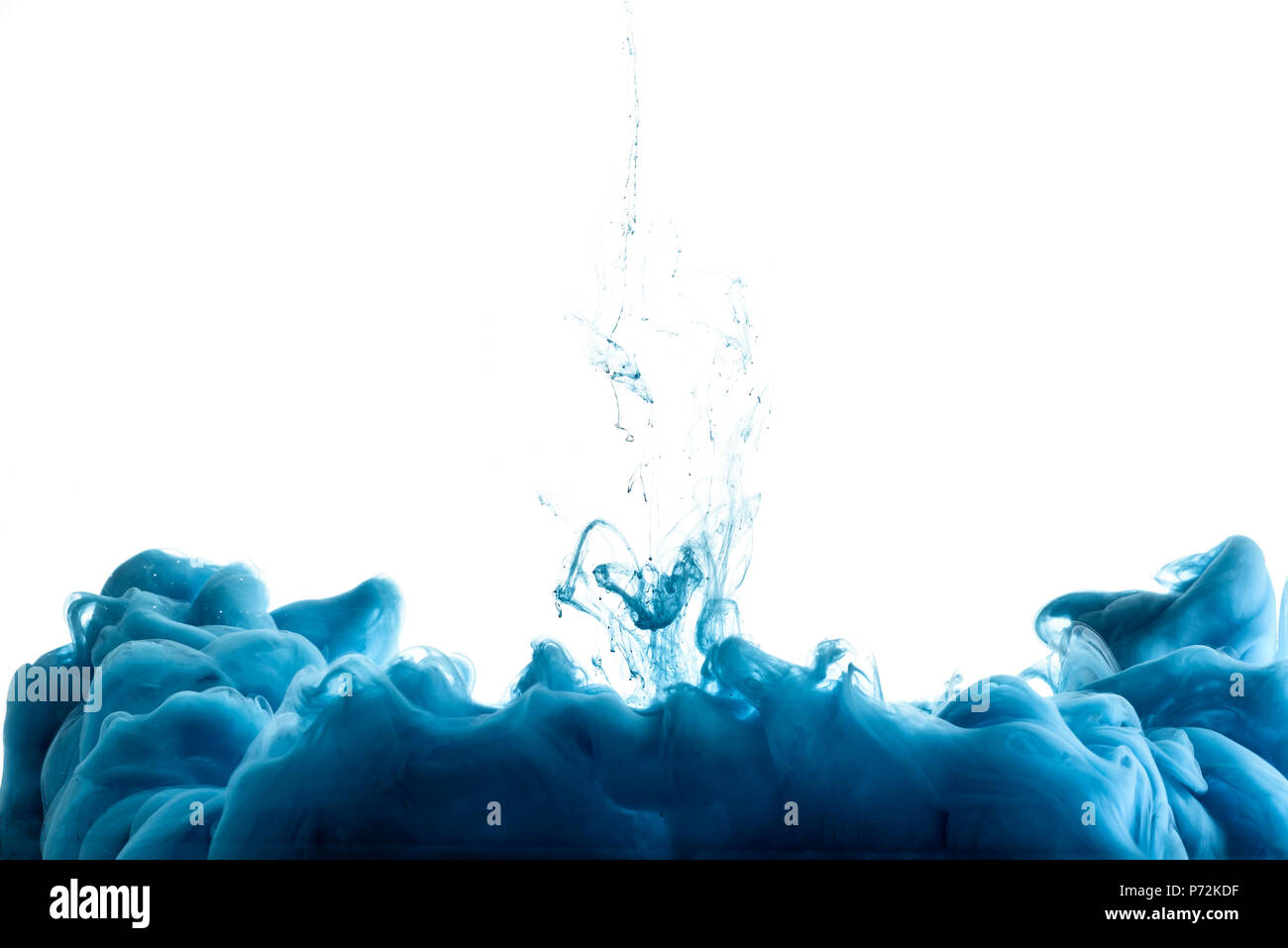 close up view of blue paint splash in water, isolated on white with ...
