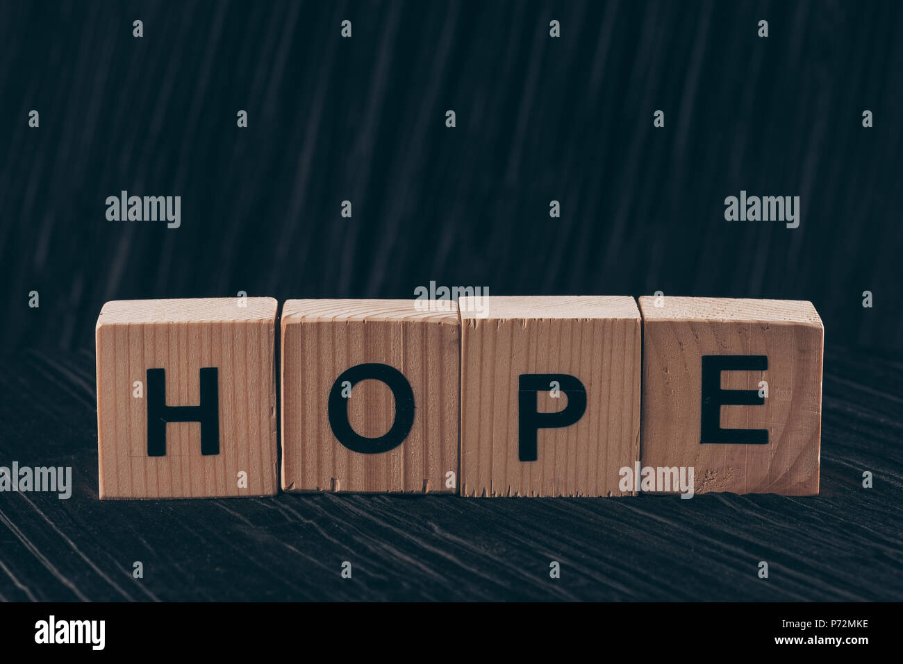 wooden cubes with word Hope on black table Stock Photo - Alamy