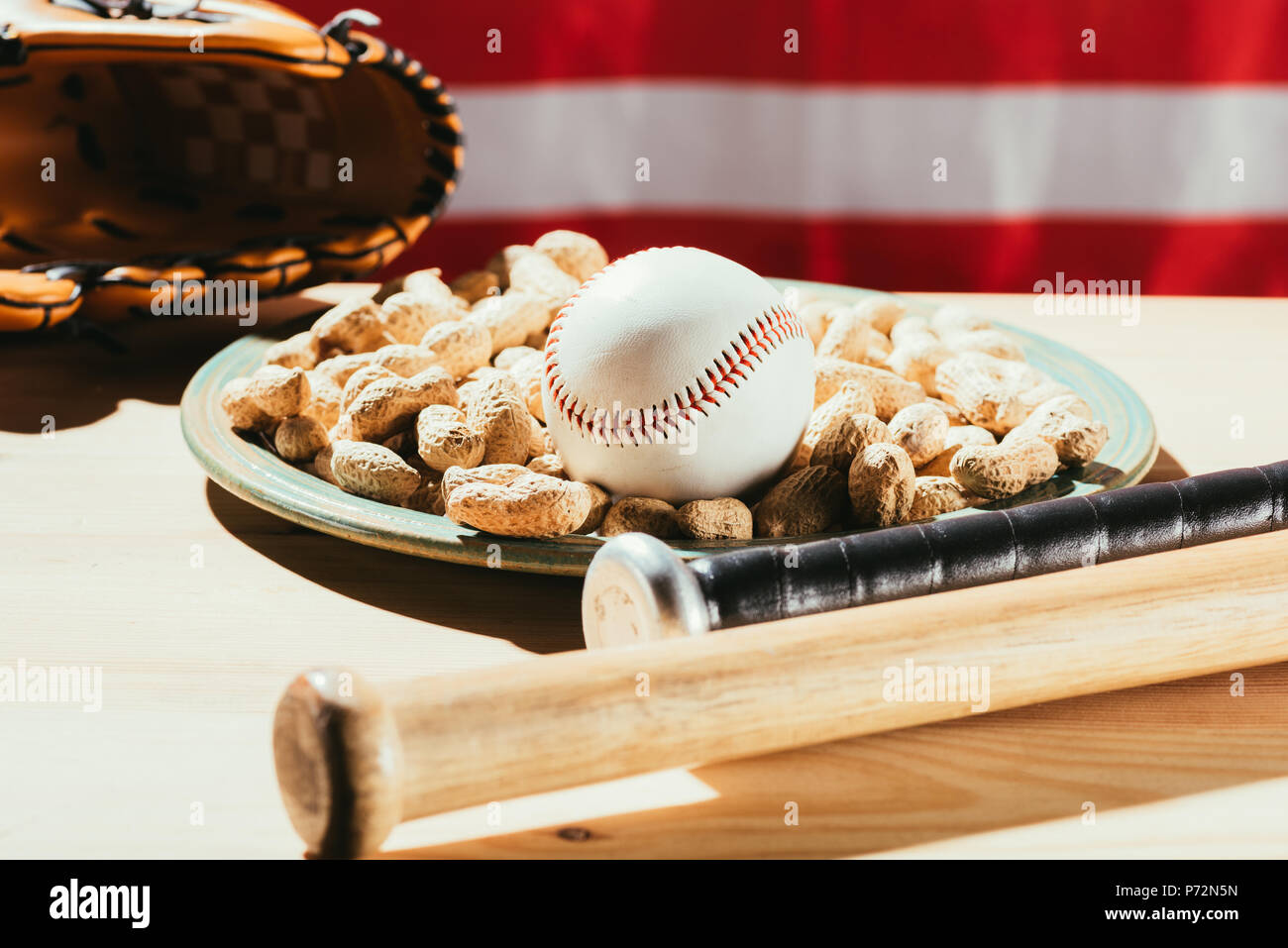 close-up view of baseball bats, baseball ball on plate with peanuts and ...