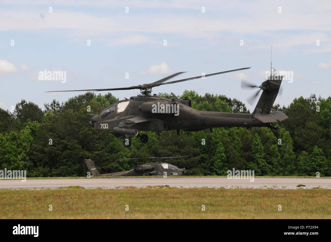 Two AH-64D Apache helicopters maneuver on Ech Stagefield, Fort Rucker ...