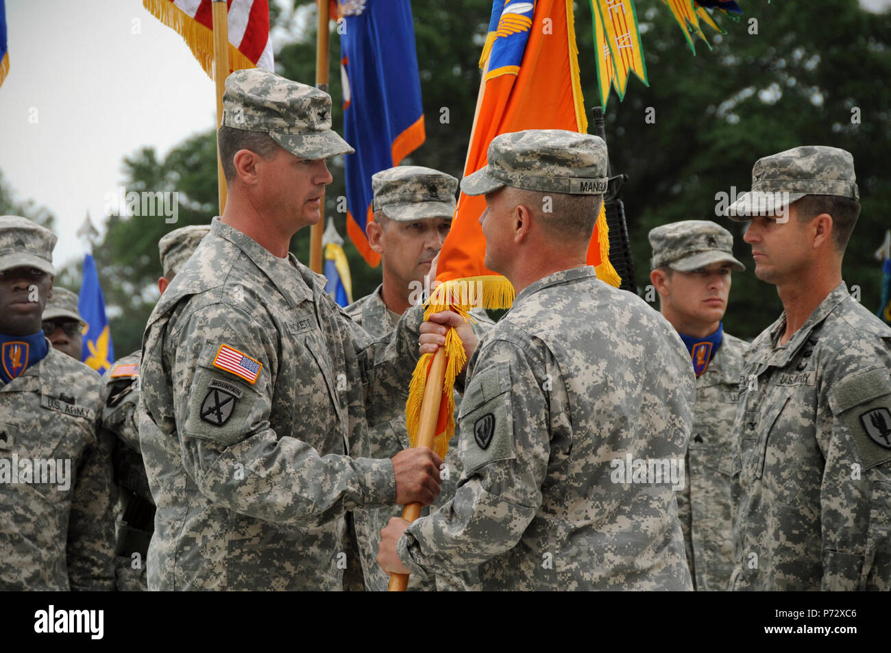 Col. Shawn Prickett (left), accepts the 1st Aviation Brigade colors ...