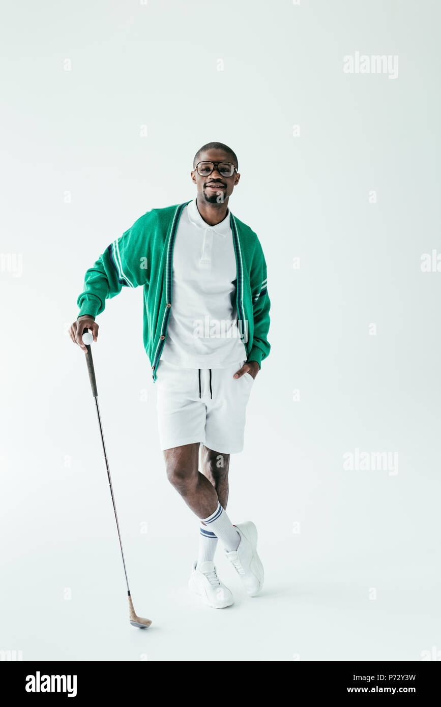 african american golfer in retro sportswear with golf club and ball ...