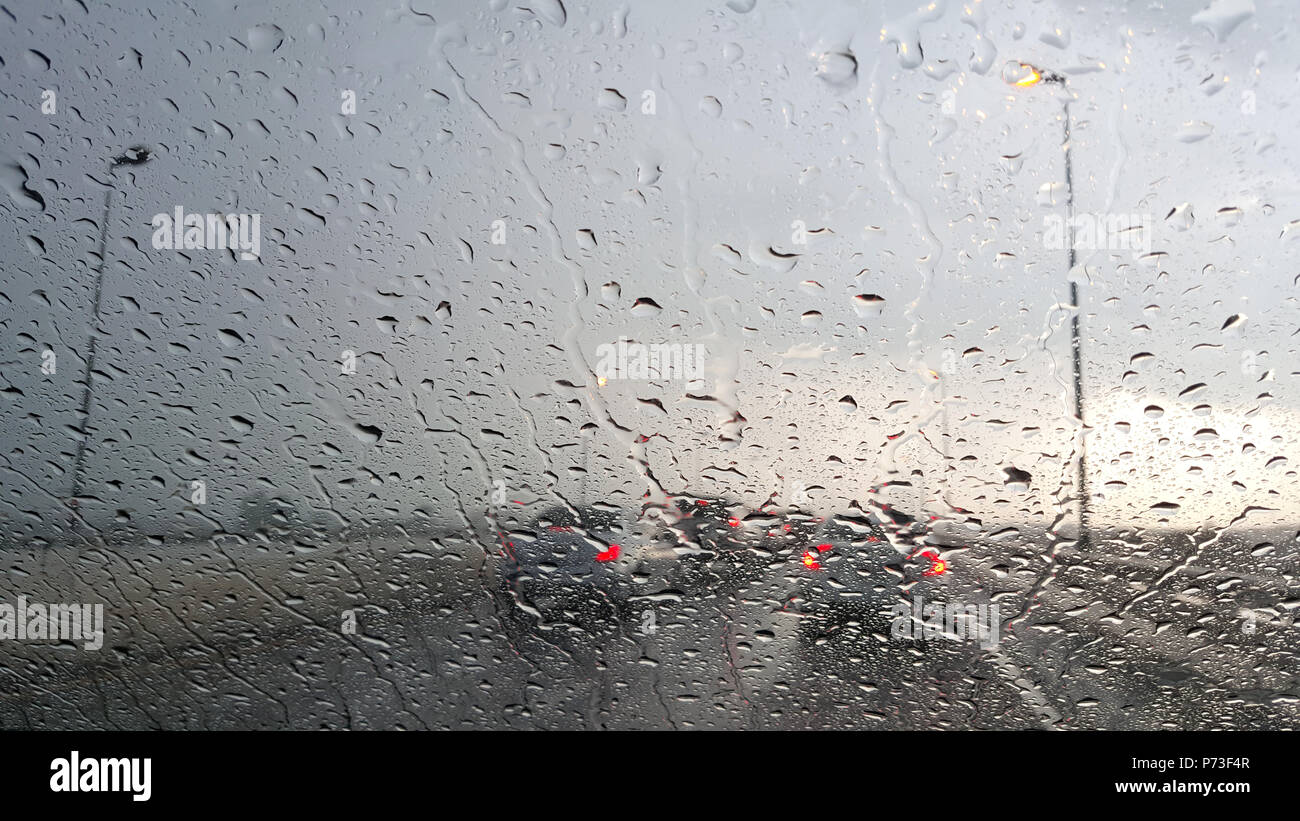 Inside the car. Closeup rain water drops. car windshield view during ...