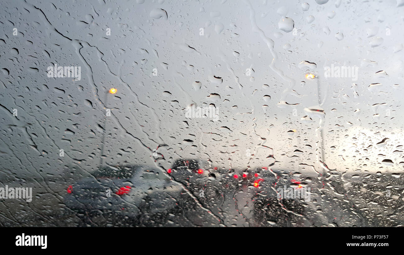 Inside the car. Closeup rain water drops. car windshield view during ...