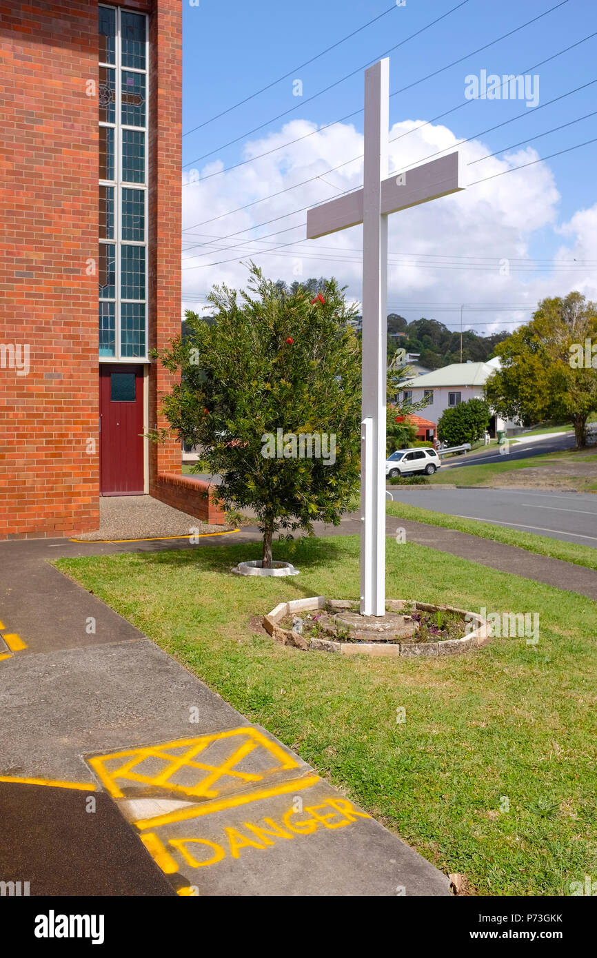 danger warning sign next to cross at the st augustine's catholic church ...