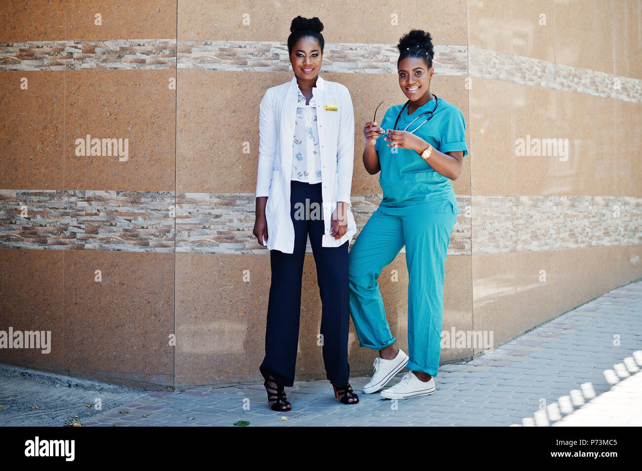 Two african american doctors female at lab coat with stethoscope posed ...