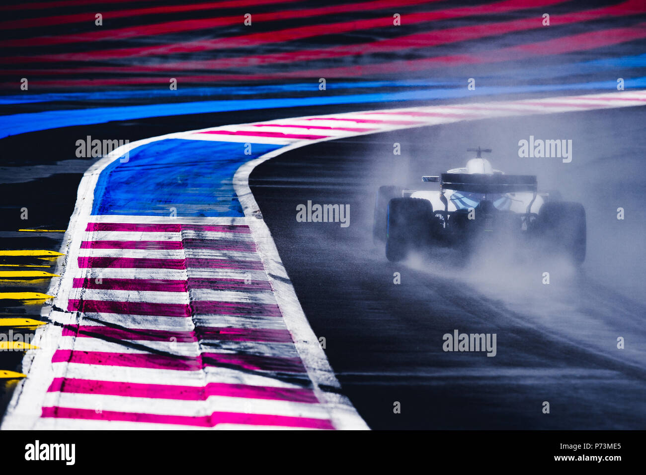 Williams racing driver Lance Stroll makes his way through the rain in a ...