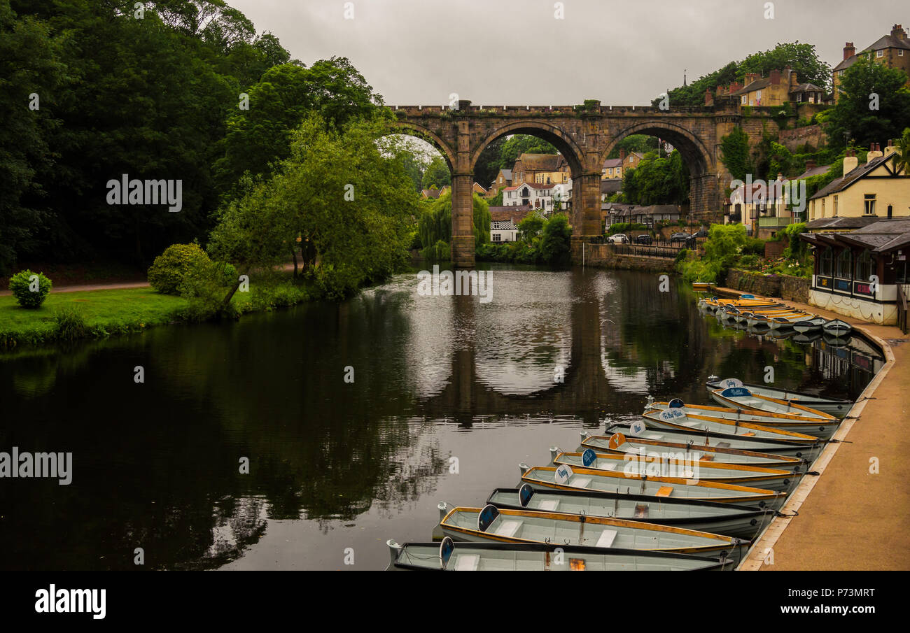 View of the Nidd River, the old bridge and rowing boats from the ruins ...