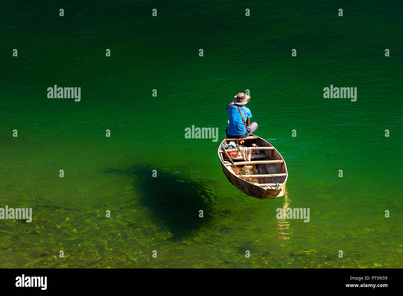 BOAT ON TRANSPARENT WATERS, UMNGOT RIVER, DAWKI, MEGHALAYA, INDIA. The ...