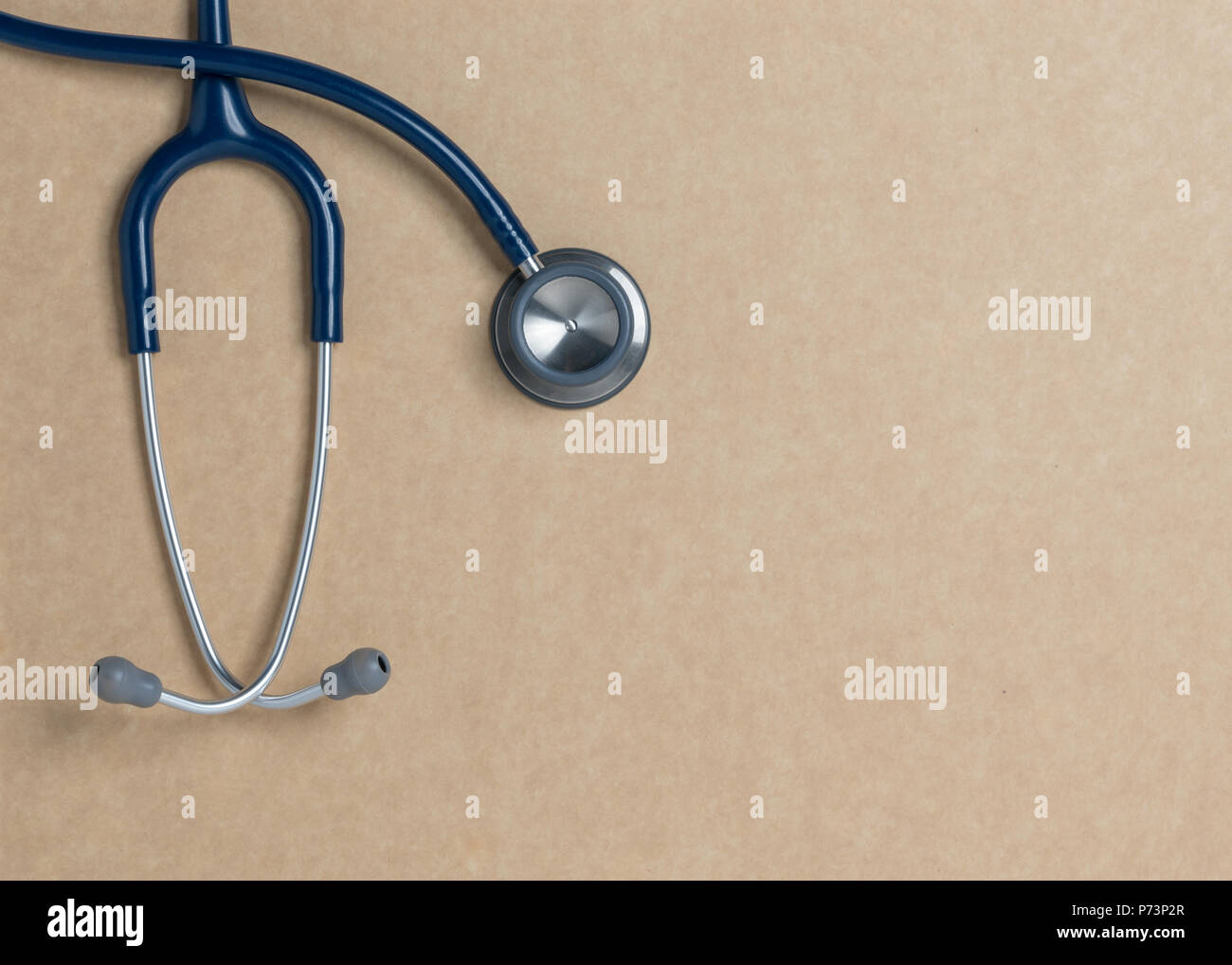 Top view blue stethoscope on yellow background. For check heart or ...