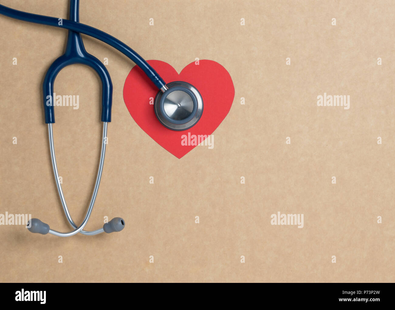 Top view blue stethoscope on yellow background. For check heart or ...