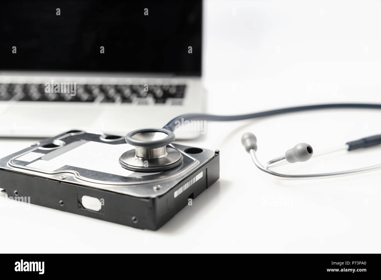 Stethoscope and hard disk drive on white background. Computer hardware ...