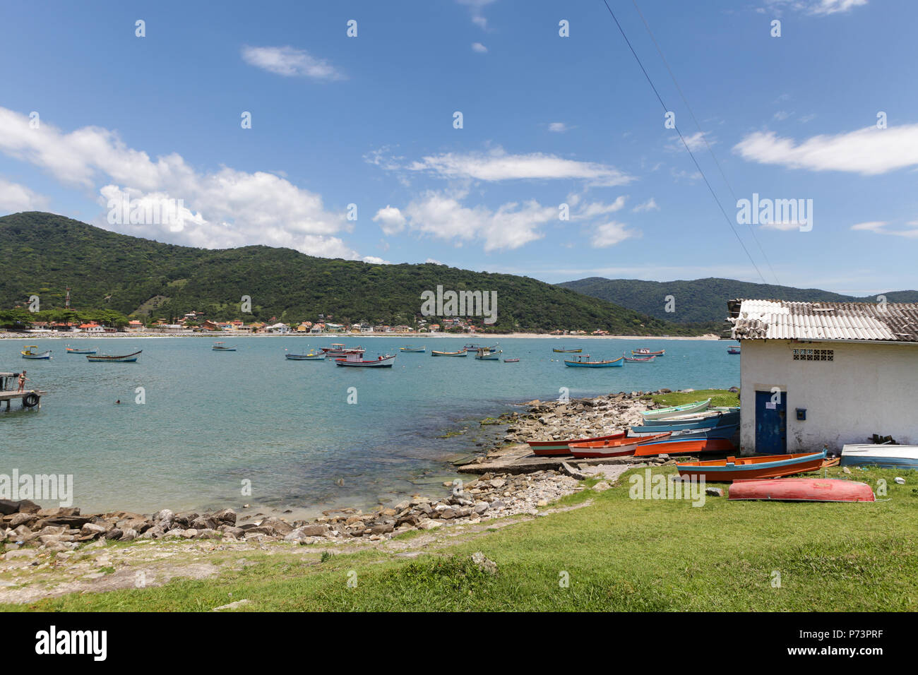 Beach and sea with hills in the background hi-res stock photography and ...