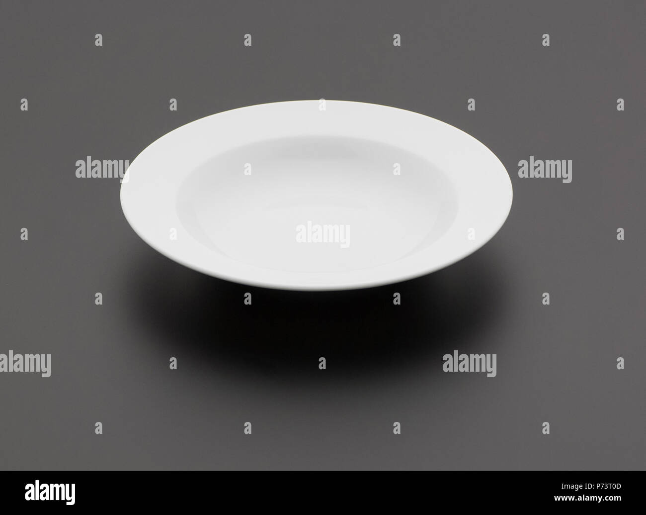 ceramic kitchen plate on black background Stock Photo - Alamy