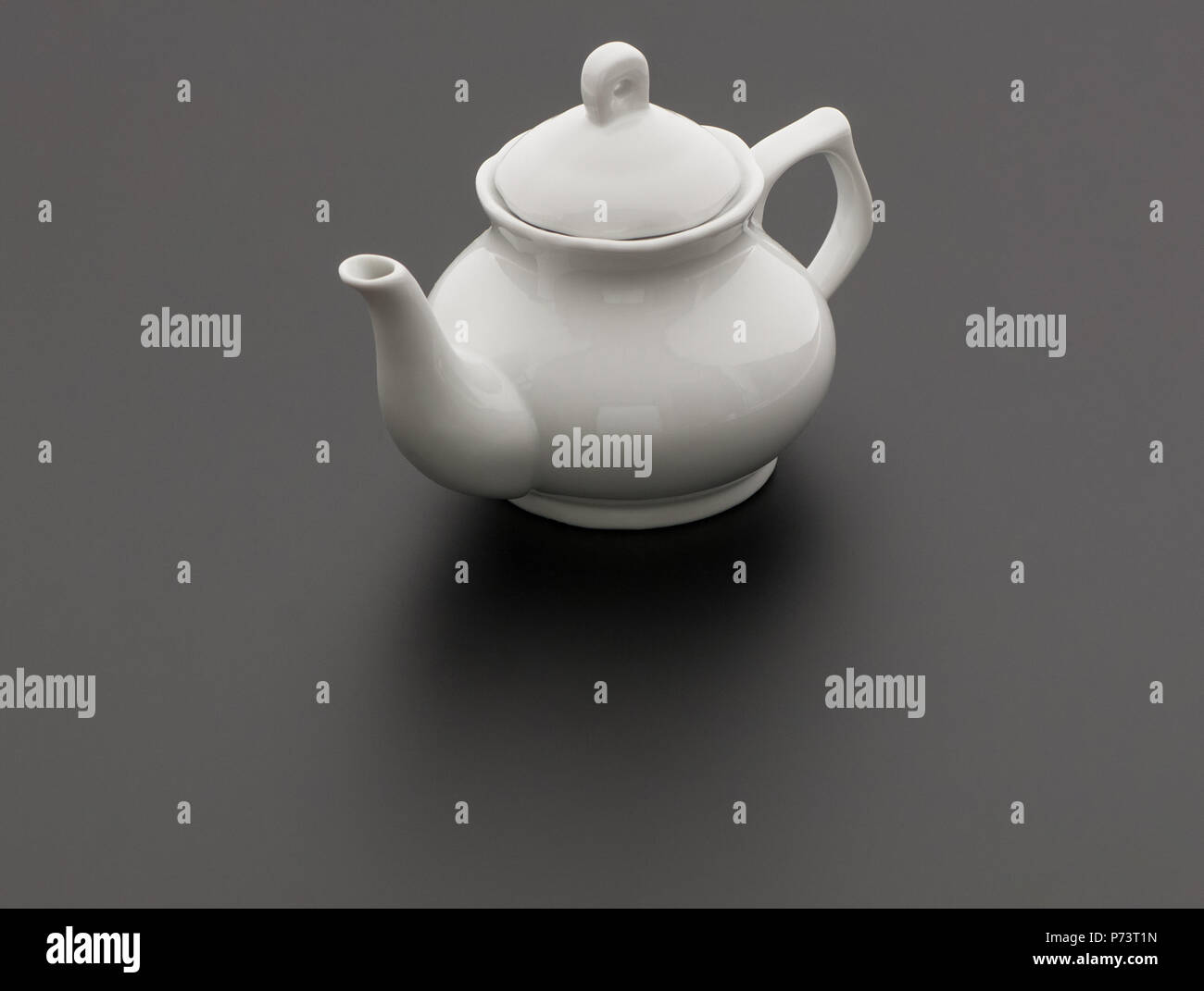 ceramic kitchen teapot on black background Stock Photo - Alamy