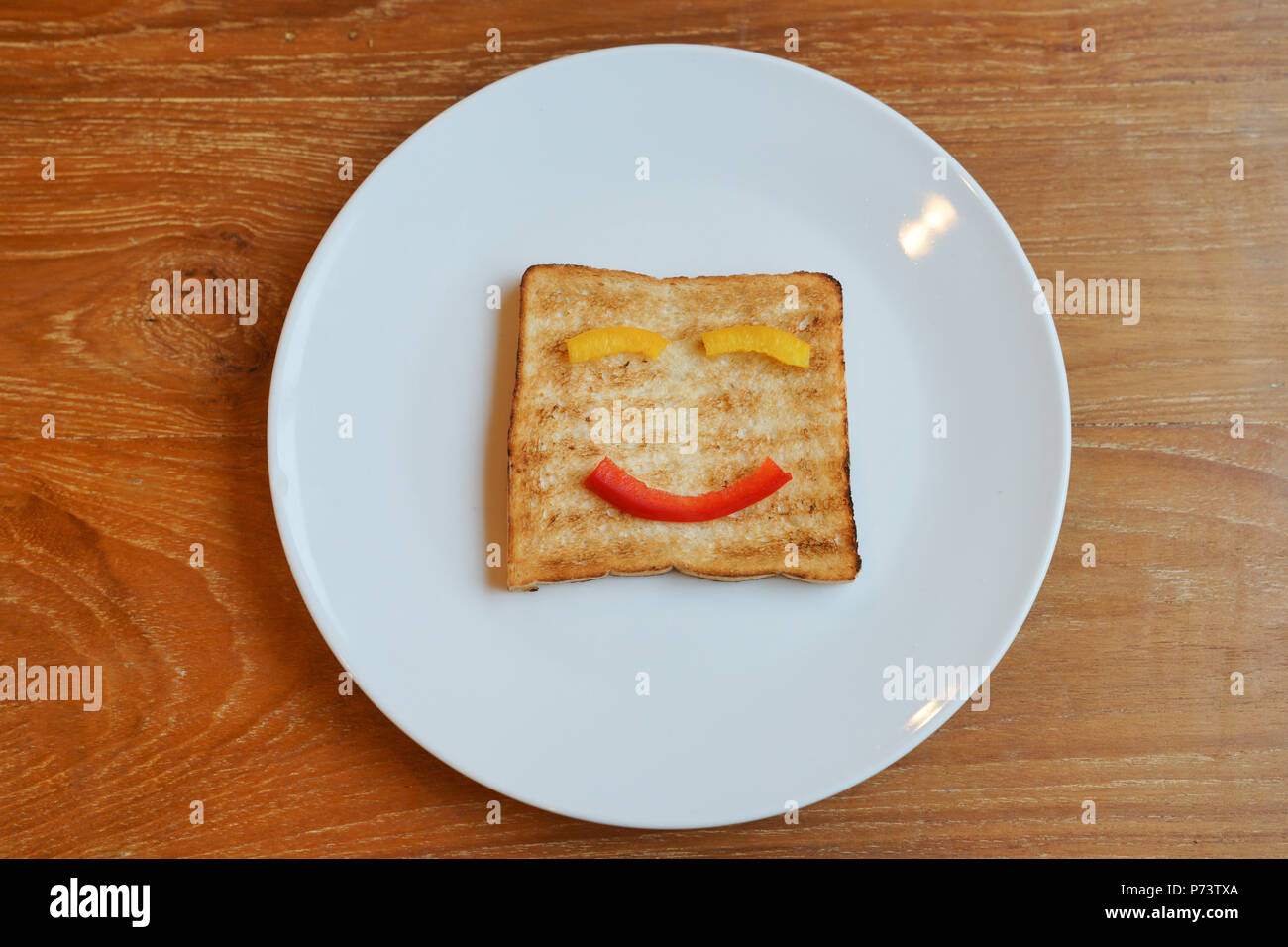The smiling faces painted on the slice bread, Happy breakfast Concept ...