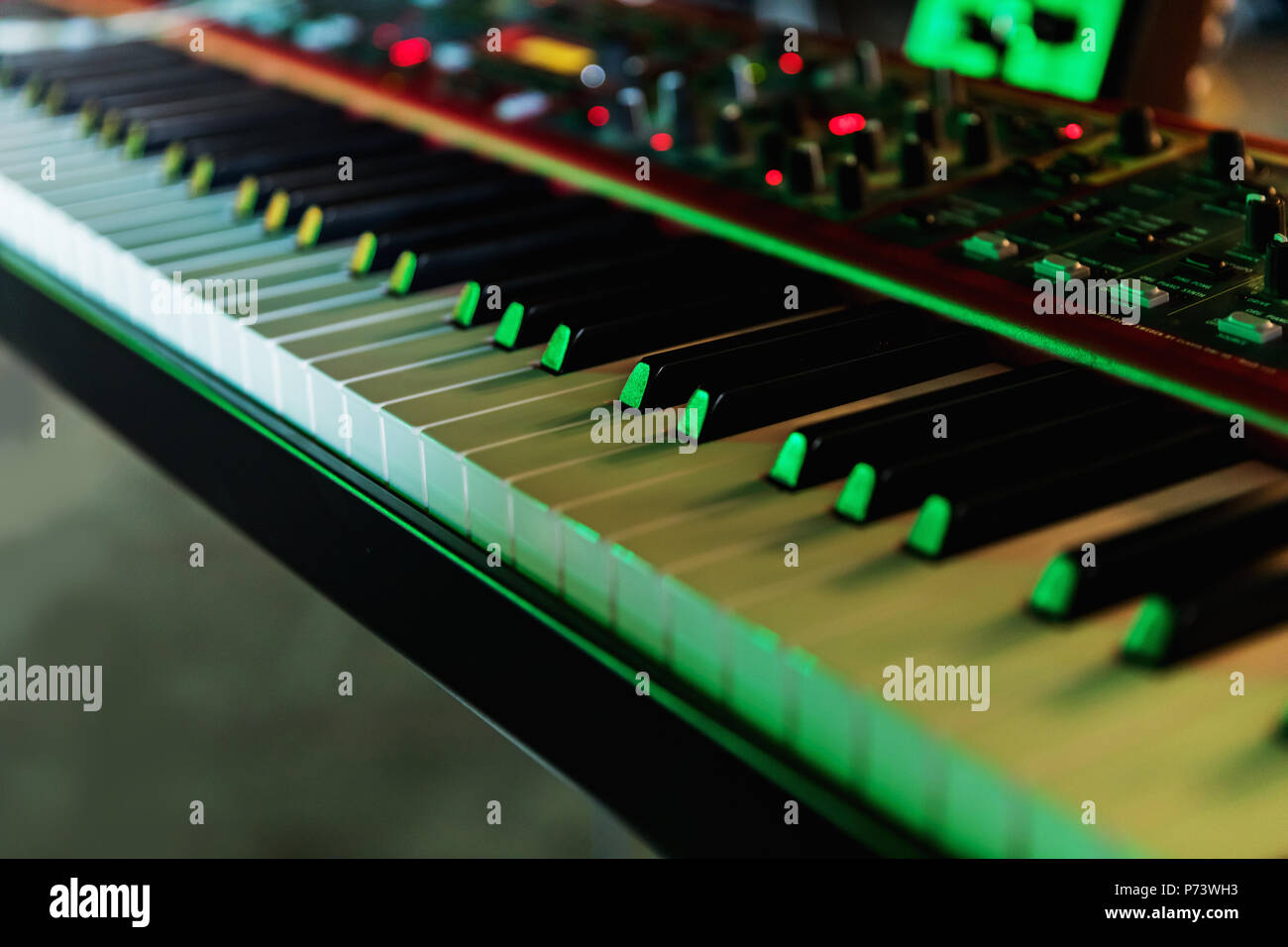 Keyboard of synthesizer in detail in tinted green Stock Photo - Alamy