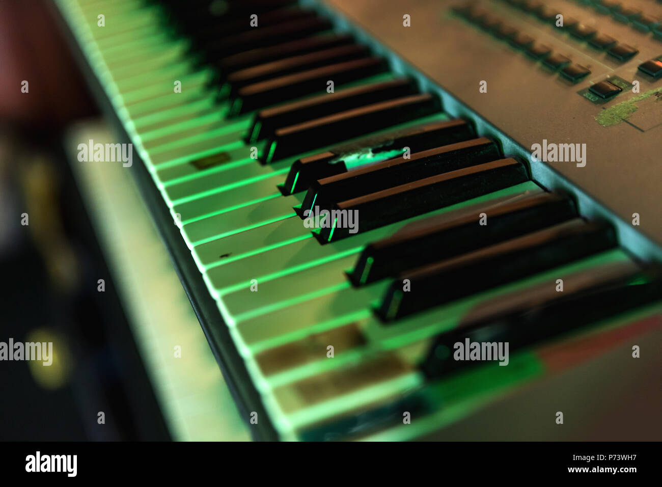 Keyboard of synthesizer in detail in tinted green Stock Photo - Alamy