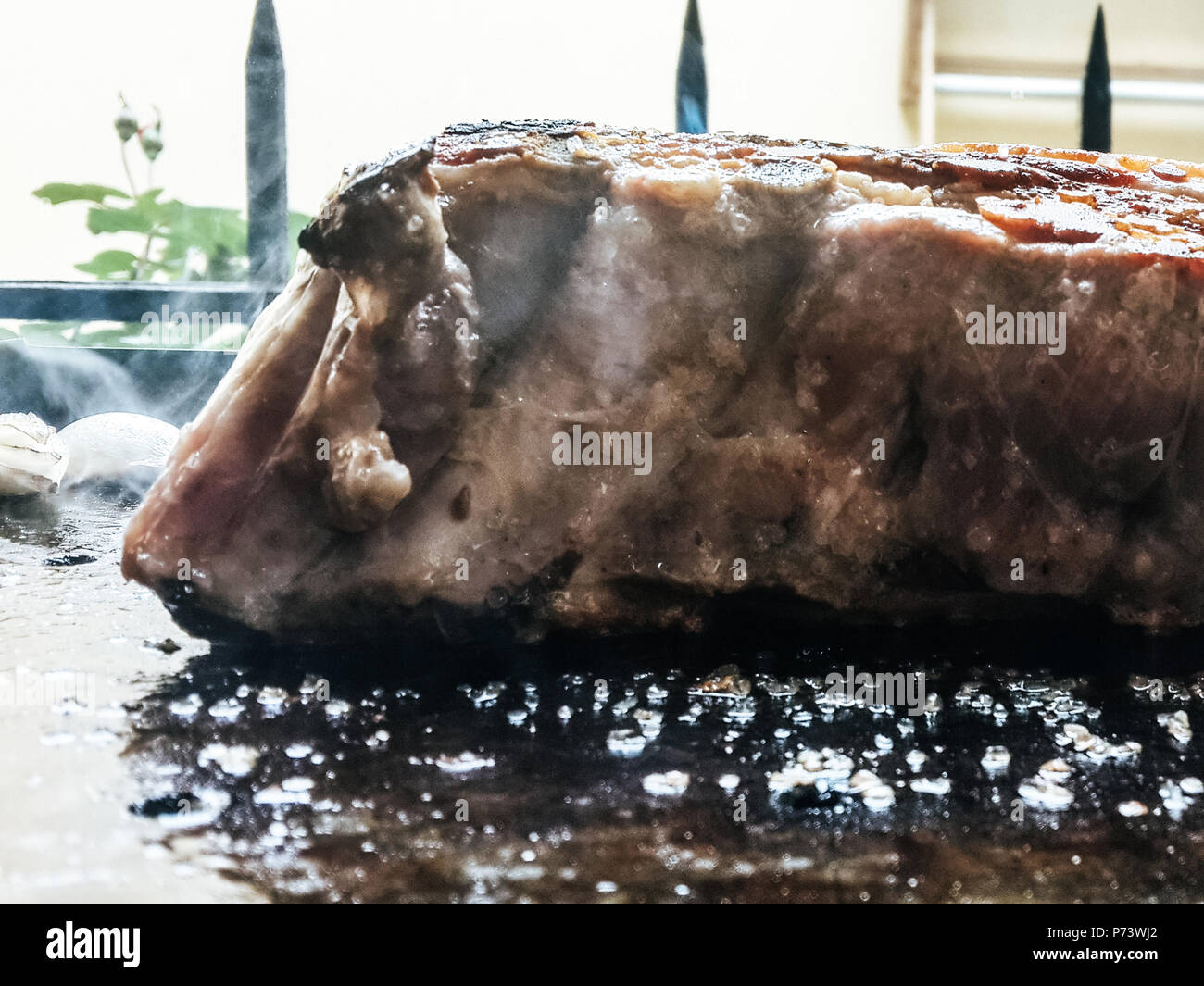 A top sirloin steak flame broiled on a barbecue, shallow depth of field ...