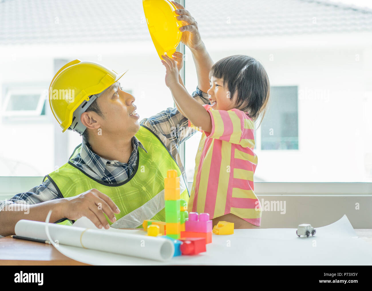 Architect working on blueprint. Architects workplace and asian little ...