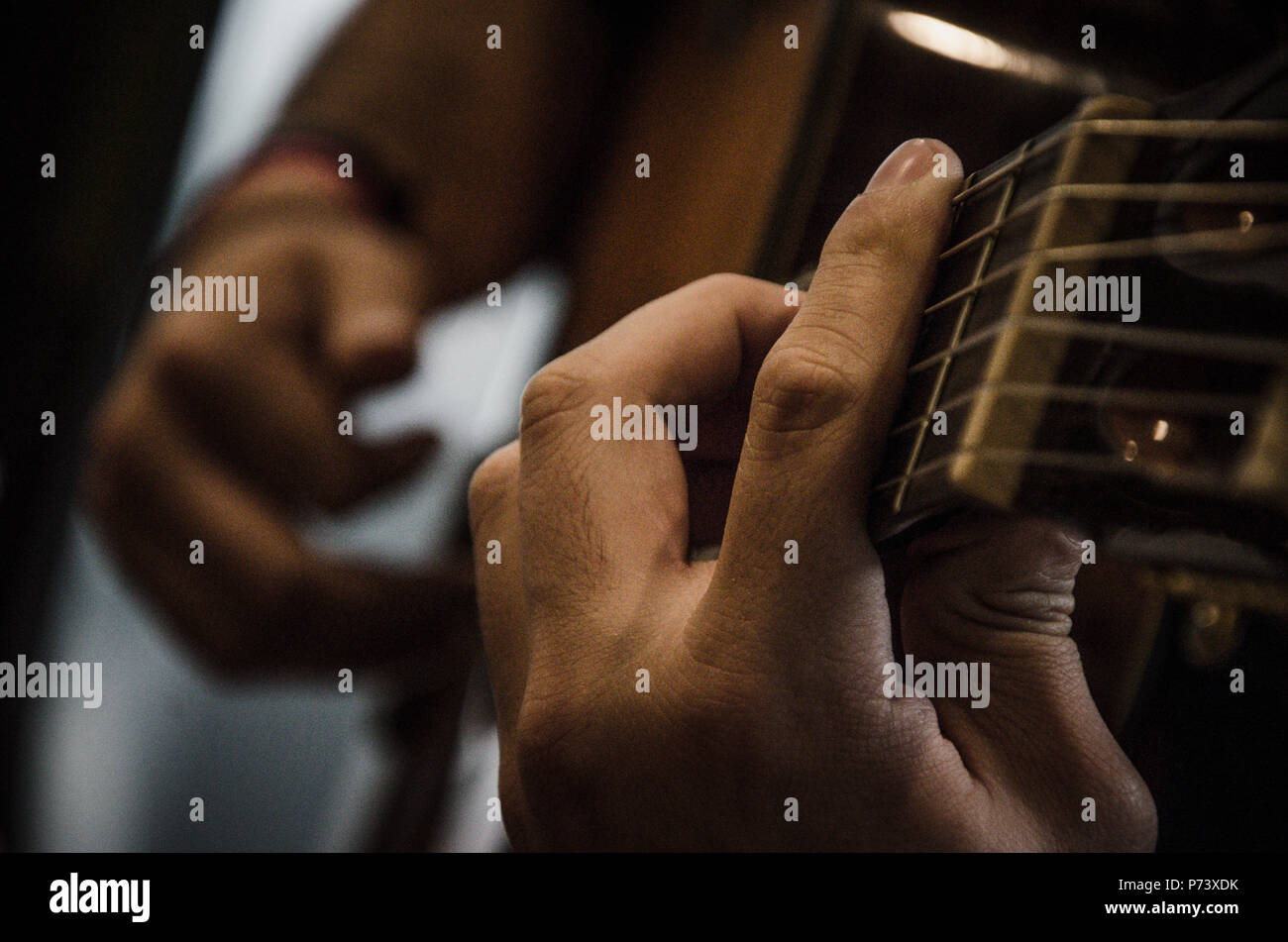 Closed shot where you can see the artist's hands and guitar Stock Photo ...